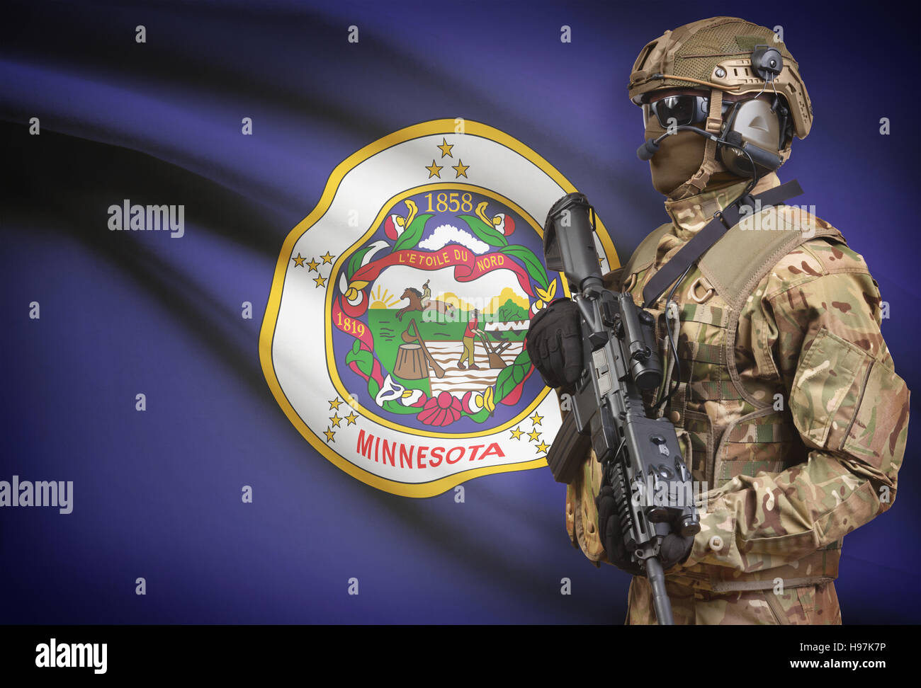 Soldier in helmet holding machine gun with USA state flag on background ...