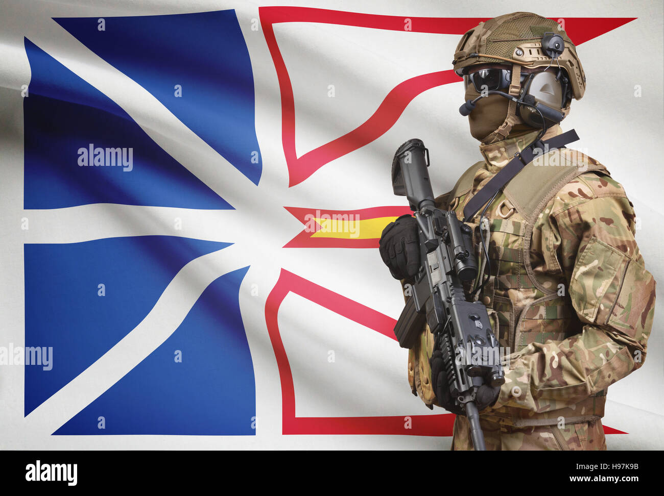 Soldier in helmet holding machine gun with Canadian province flag on ...