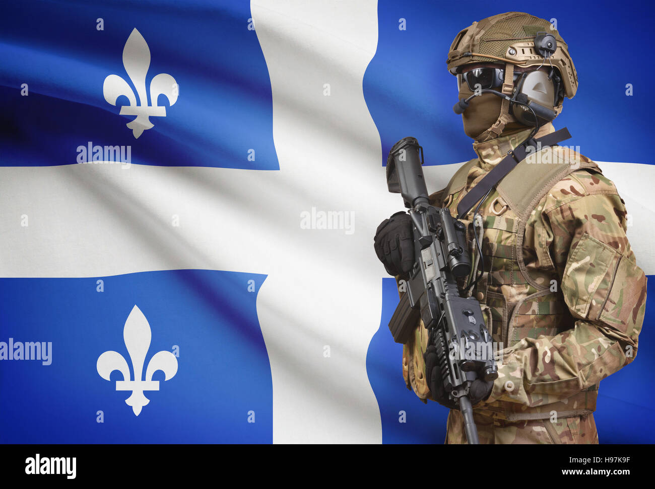 Soldier in helmet holding machine gun with Canadian province flag on ...