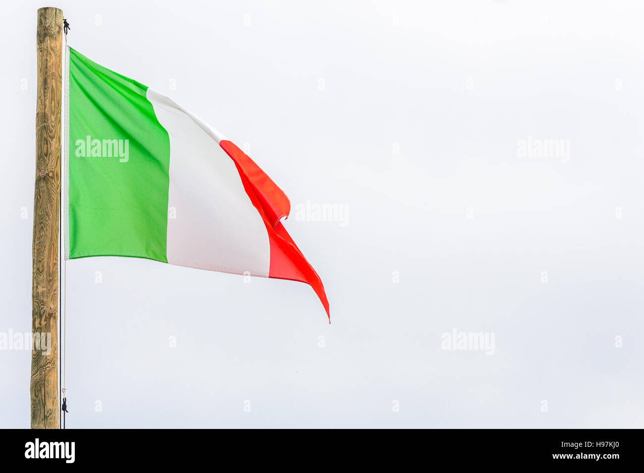 Italian flag waving on wooden pole Stock Photo - Alamy