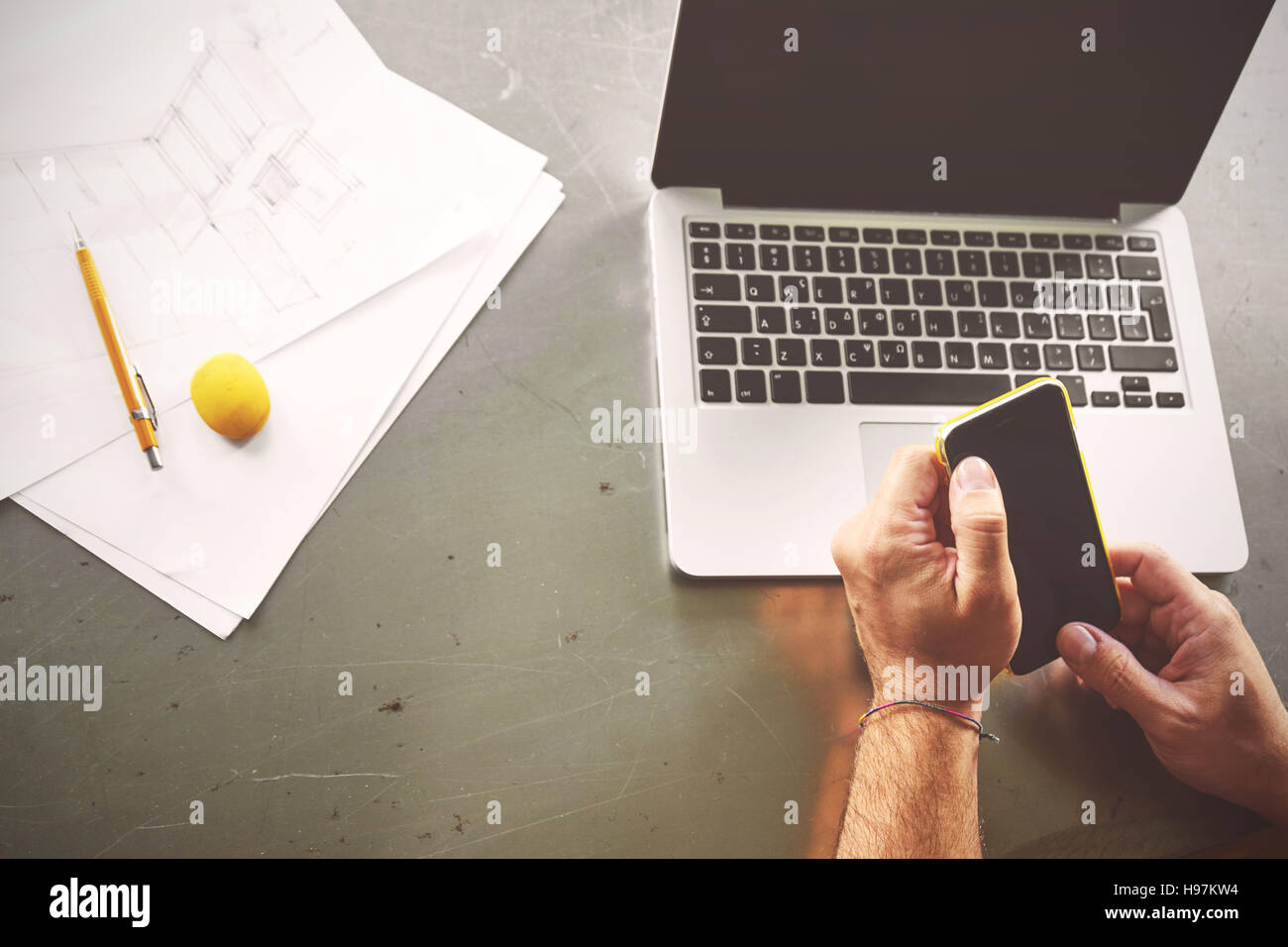 Top view of architect man working at computer and calling his client ...