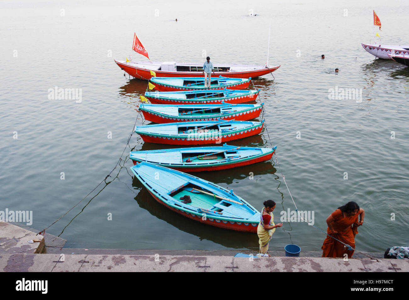 Blue boats moored on Ganges river at Varanasi, Uttar Pradesh, India ...