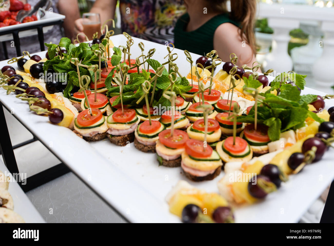 Catering service plate .appetizing sandwiches on plastic sticks ...