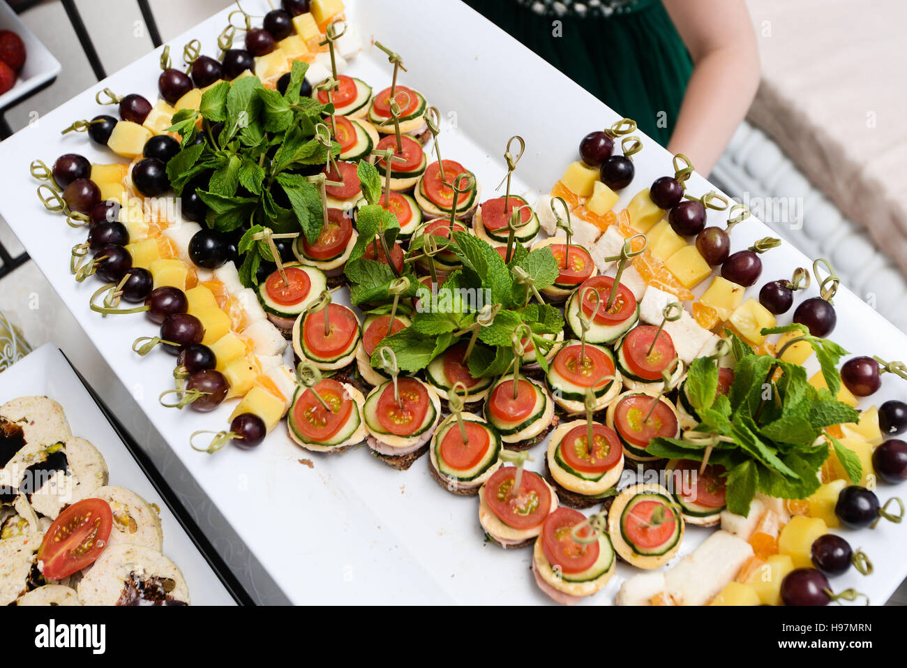 Catering service plate .appetizing sandwiches on plastic sticks ...