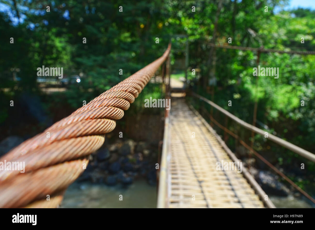 Rusty iron cable of an old bamboo suspension bridge Stock Photo - Alamy