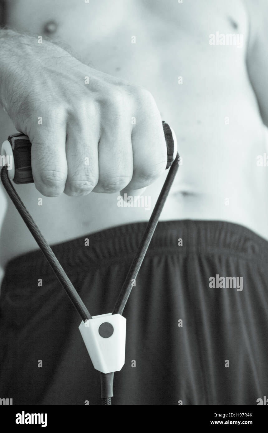 Performing exercises with resistance rope fitness Stock Photo - Alamy