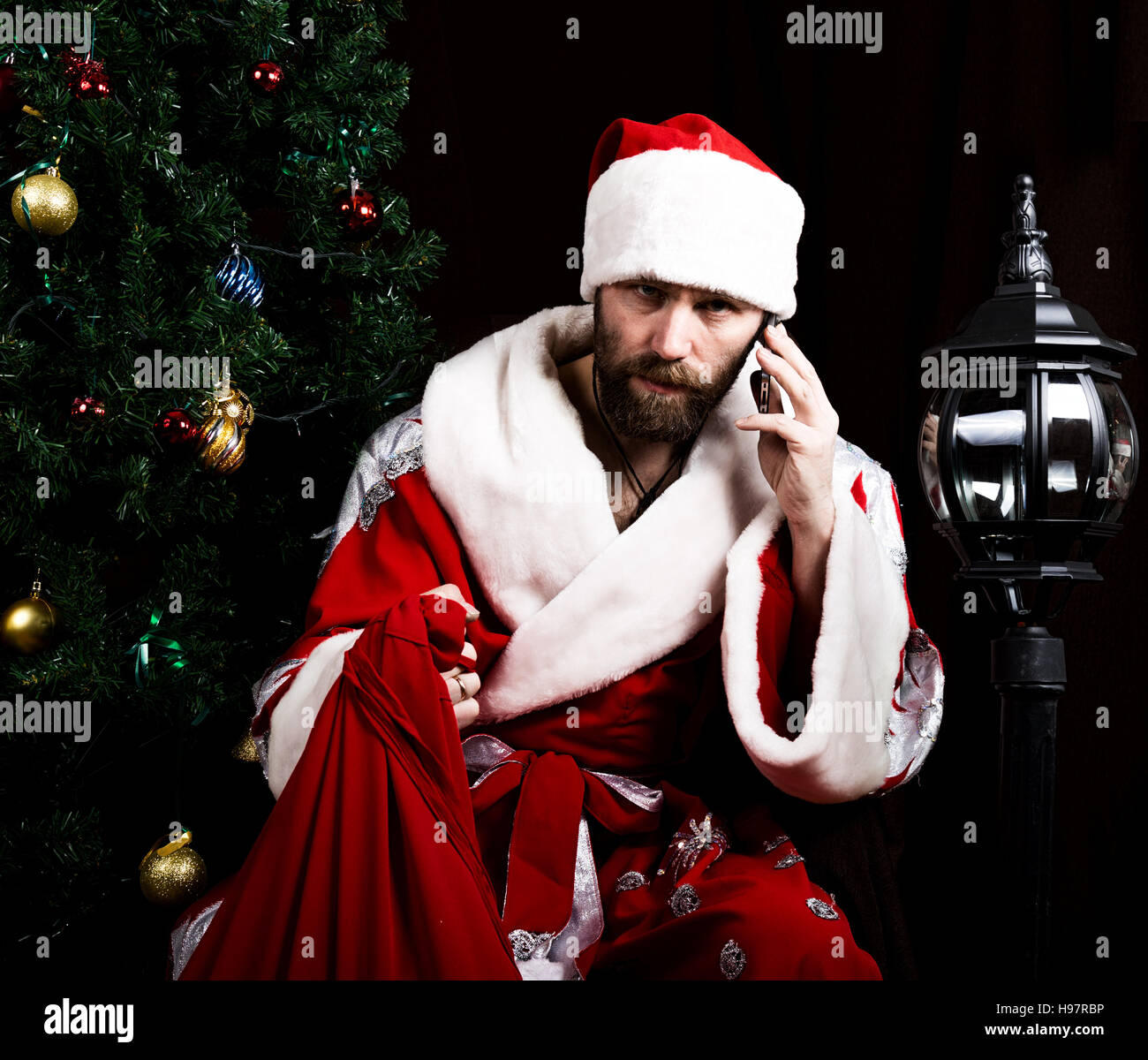 bad brutal Santa Claus holding the bag with gifts and dissatisfied ...