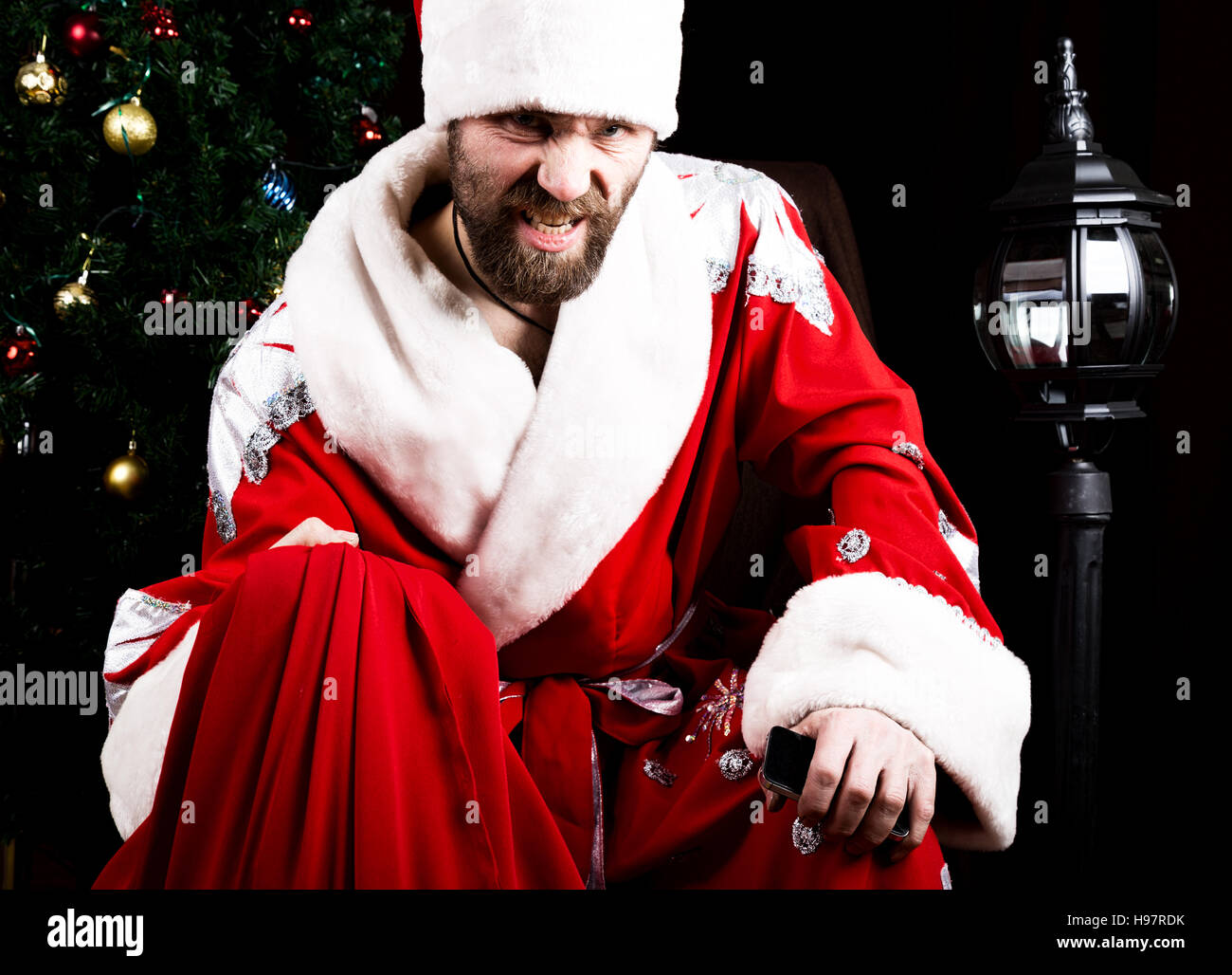 bad brutal Santa Claus holding the bag with gifts on the background of ...