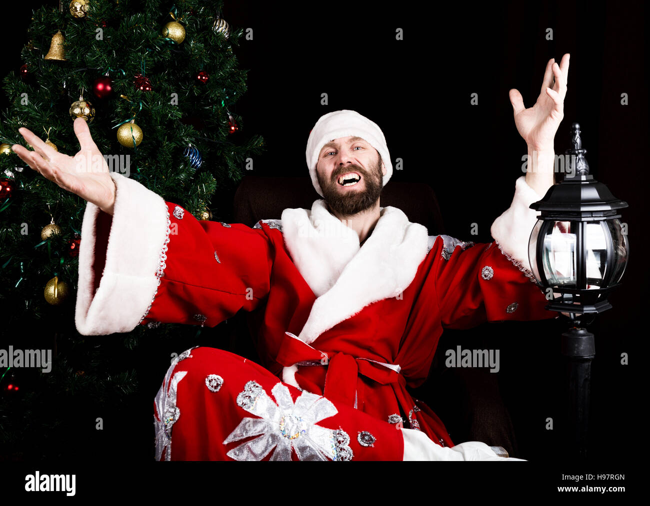 bad brutal Santa Claus smiles and spread his hands in different side on ...