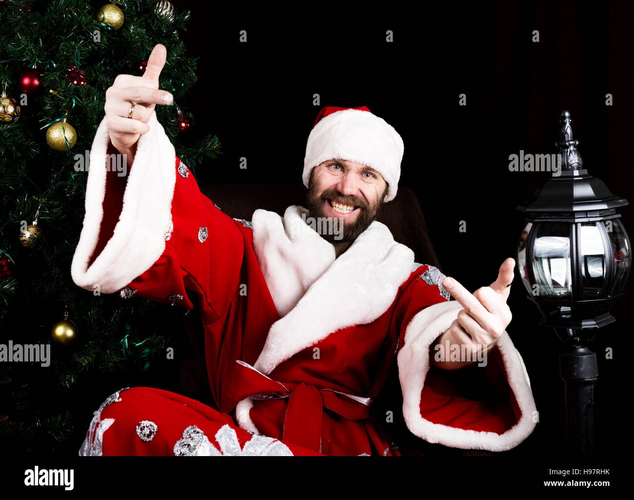 bad brutal Santa Claus smiles and showing middle finger sign on the ...