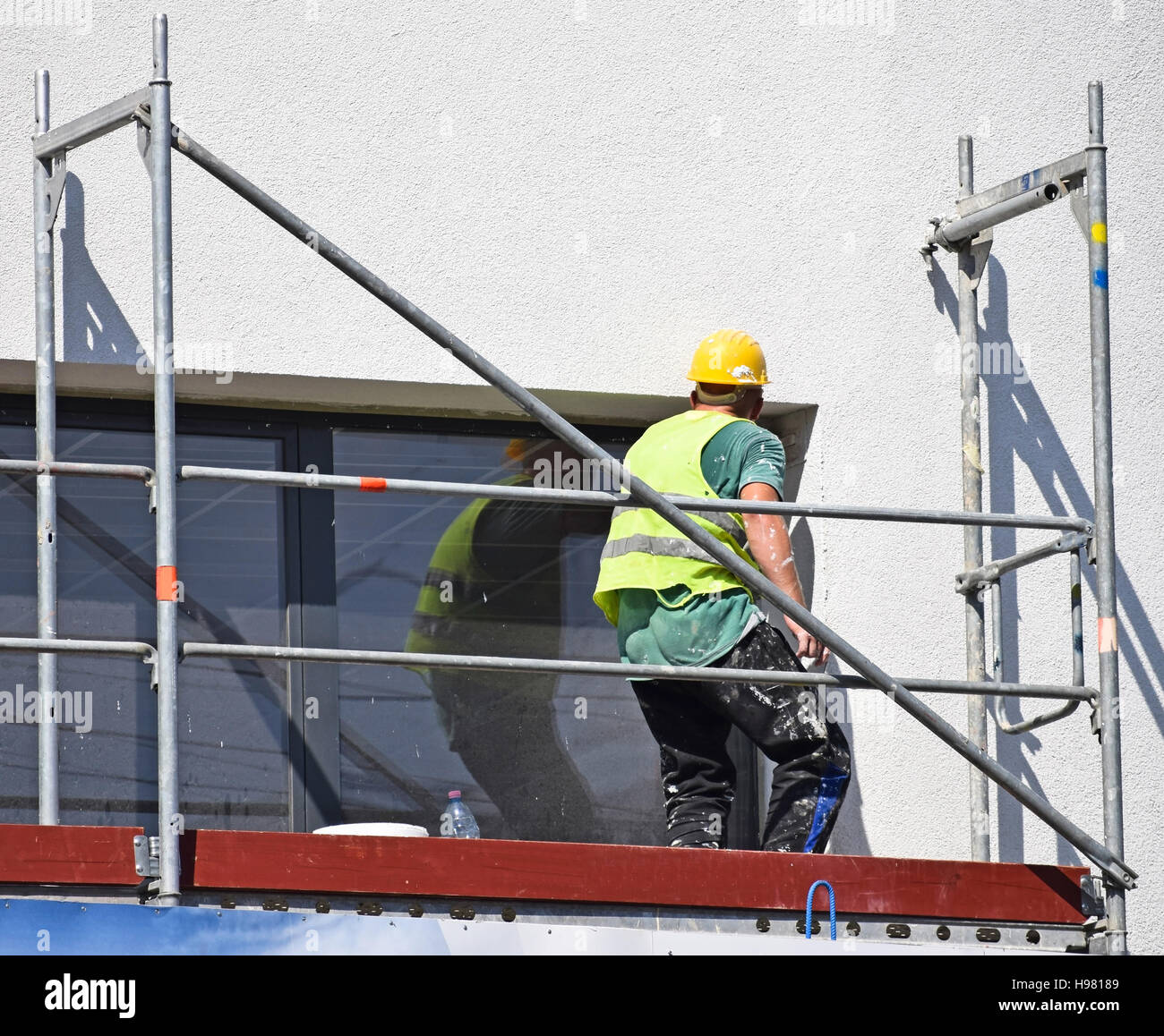 Construction worker at work on a construction frame Stock Photo - Alamy