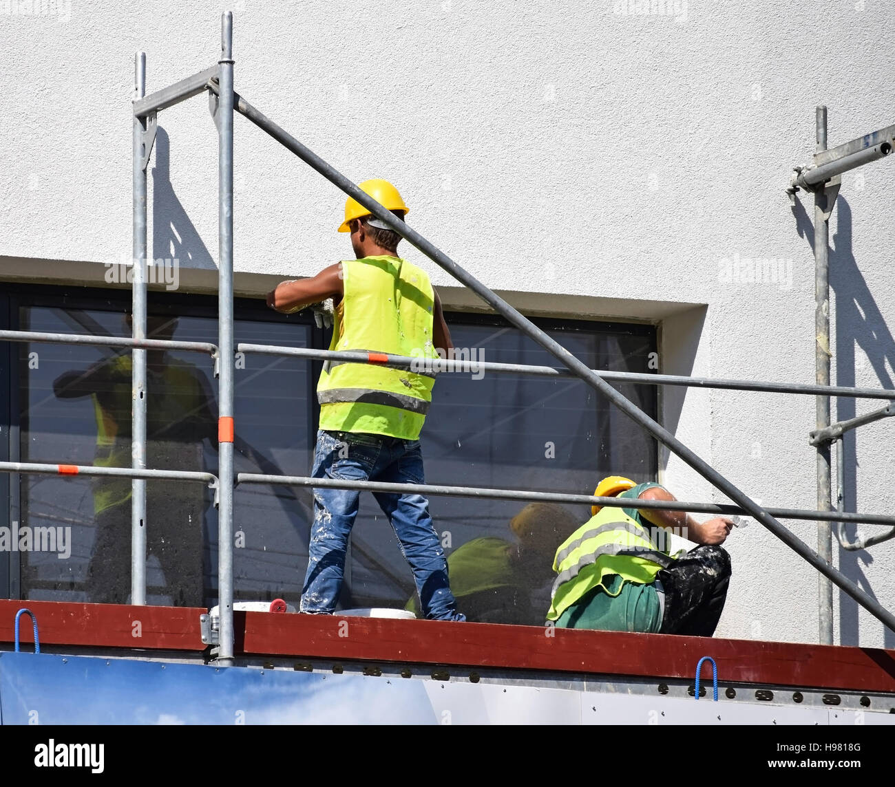 Construction workers at work on a construction frame Stock Photo - Alamy