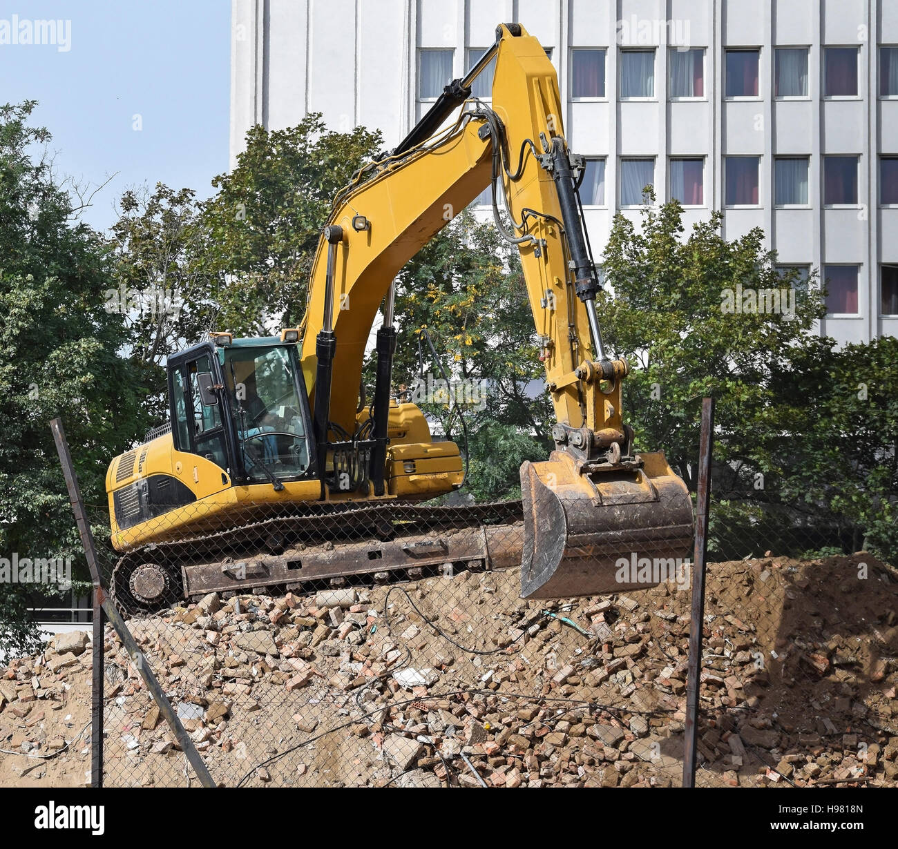 Excavator at the construction site in the city Stock Photo - Alamy