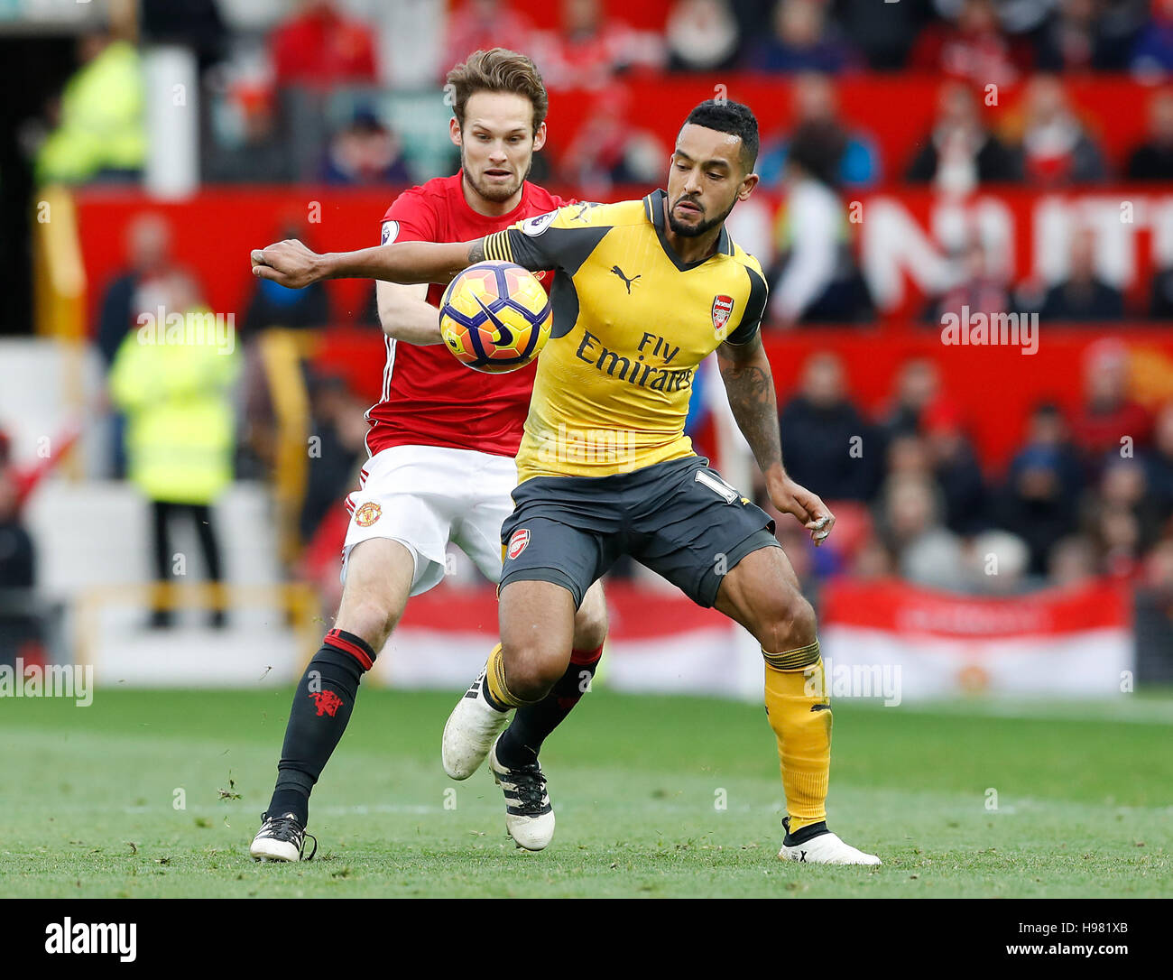 Manchester United's Daley Blind (left) and Arsenal's Theo Walcott ...