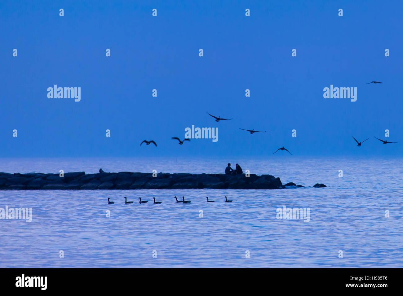 A couple walks along an outcropping of Lake Huron shoreline in Goderich ...