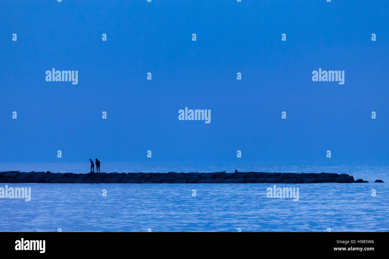 A couple walks along an outcropping of Lake Huron shoreline in Goderich ...