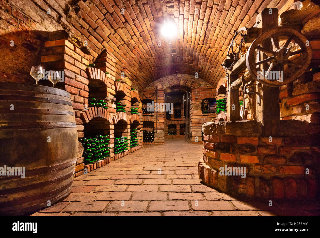 Small and old wine cellar with many full bottles and keg Stock Photo ...