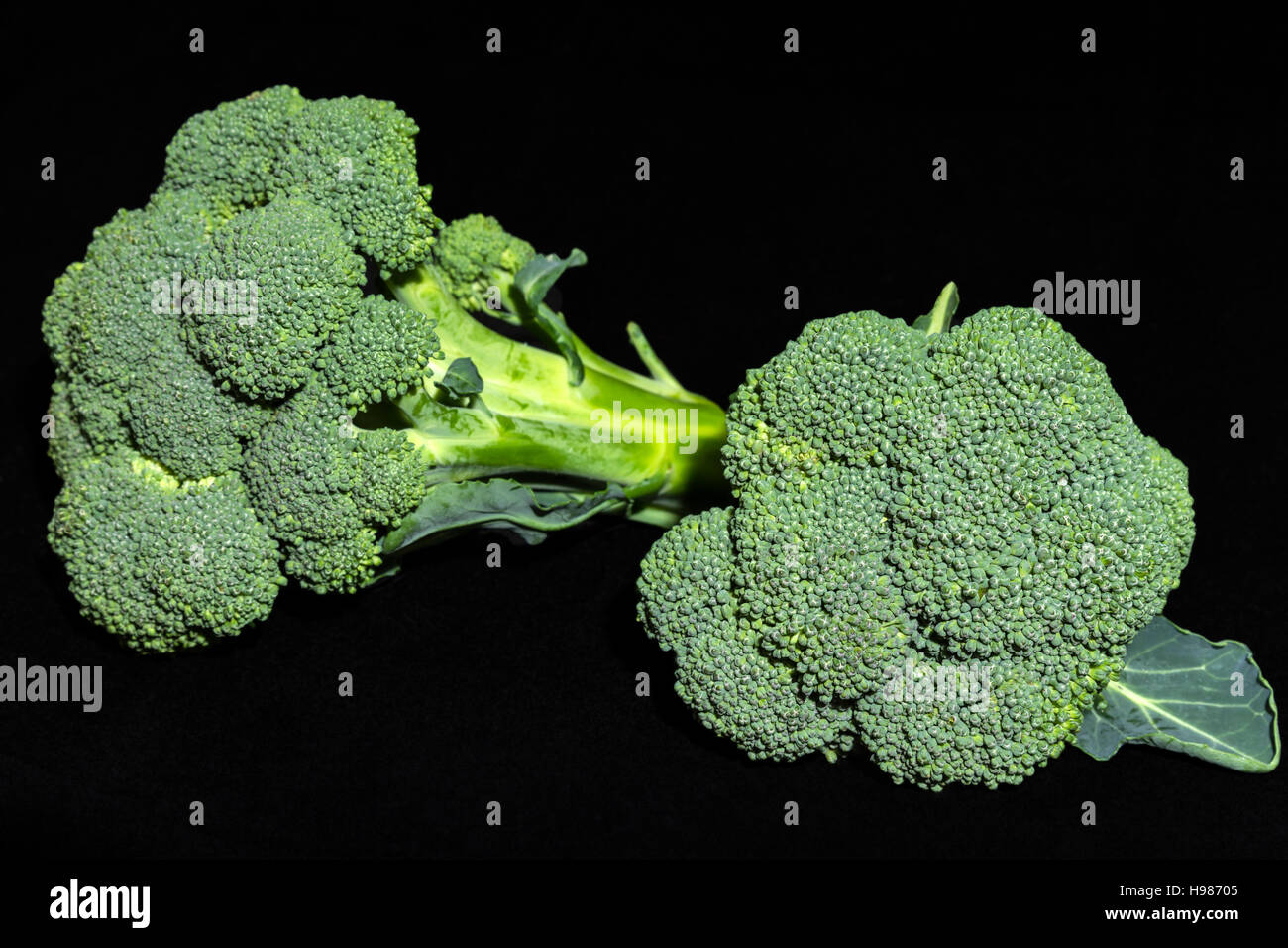 green florets of broccoli on black background Stock Photo - Alamy