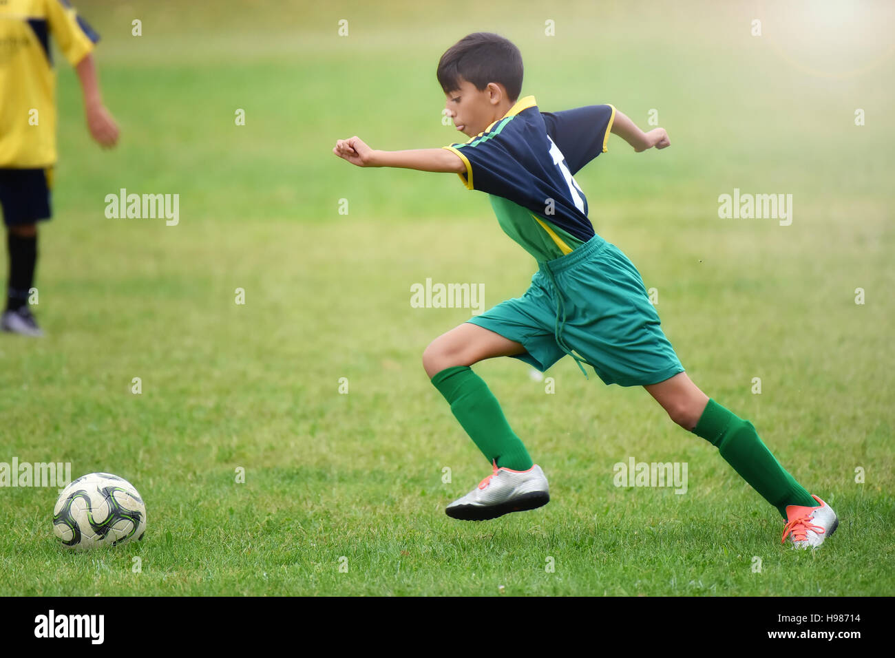 Boy playing football hi-res stock photography and images - Alamy