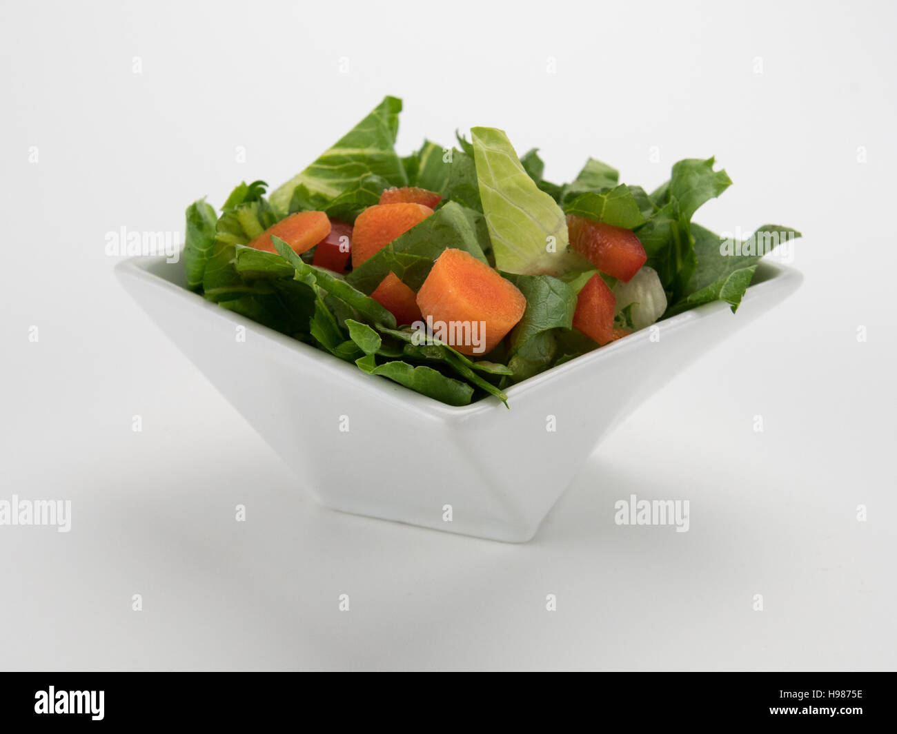 Salad no Dressing in white bowl isolated on white Stock Photo - Alamy