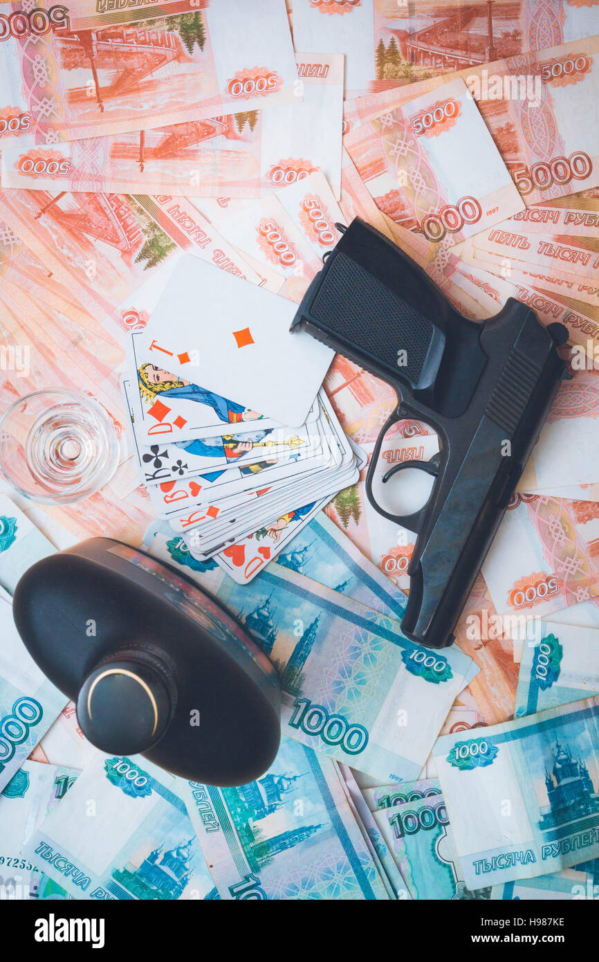 The gun and playing cards Russian big money Stock Photo - Alamy