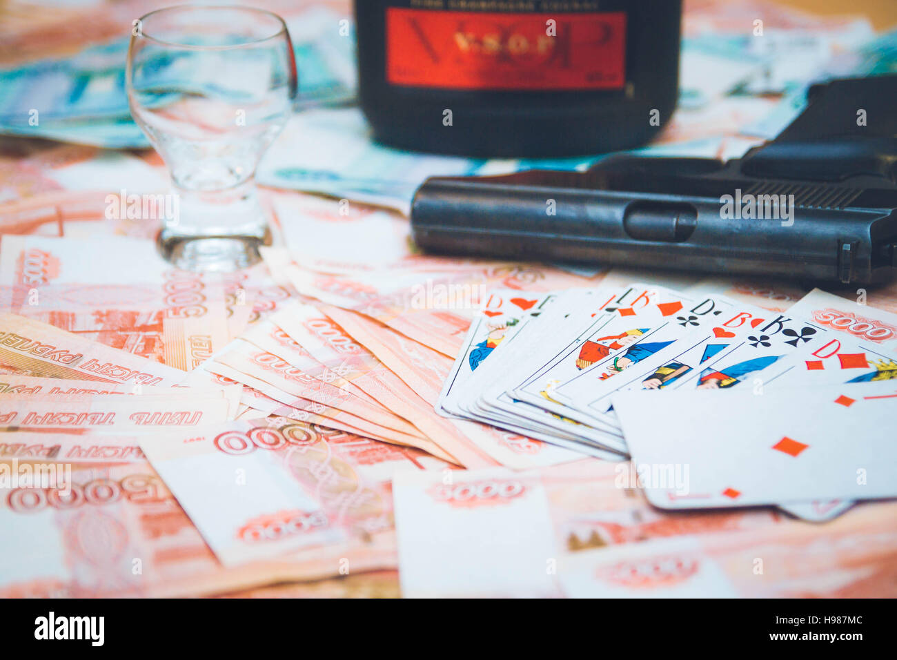 The gun and playing cards Russian big money Stock Photo - Alamy