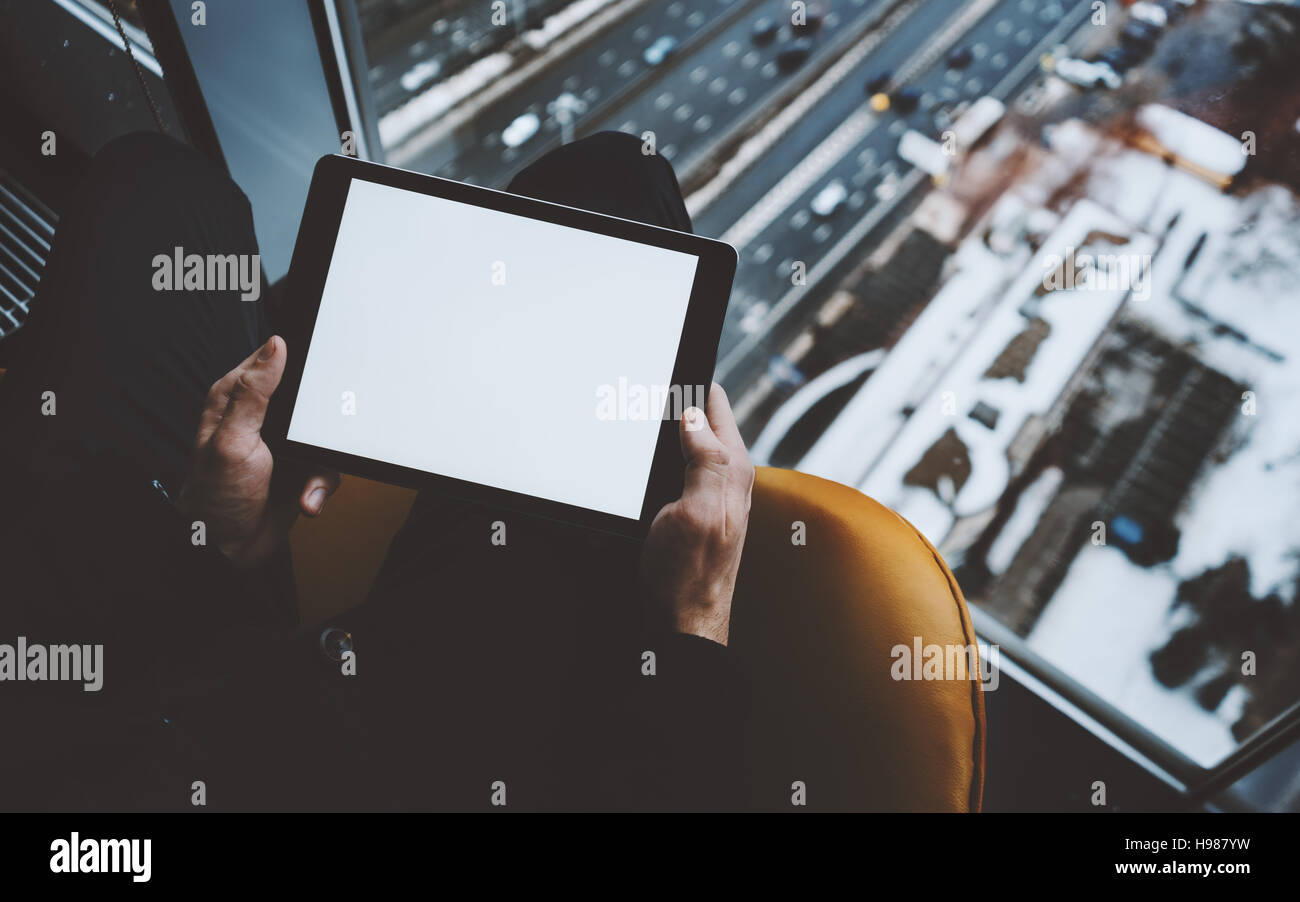 Close up view of mock up template of tablet pc in hands of man sitting ...
