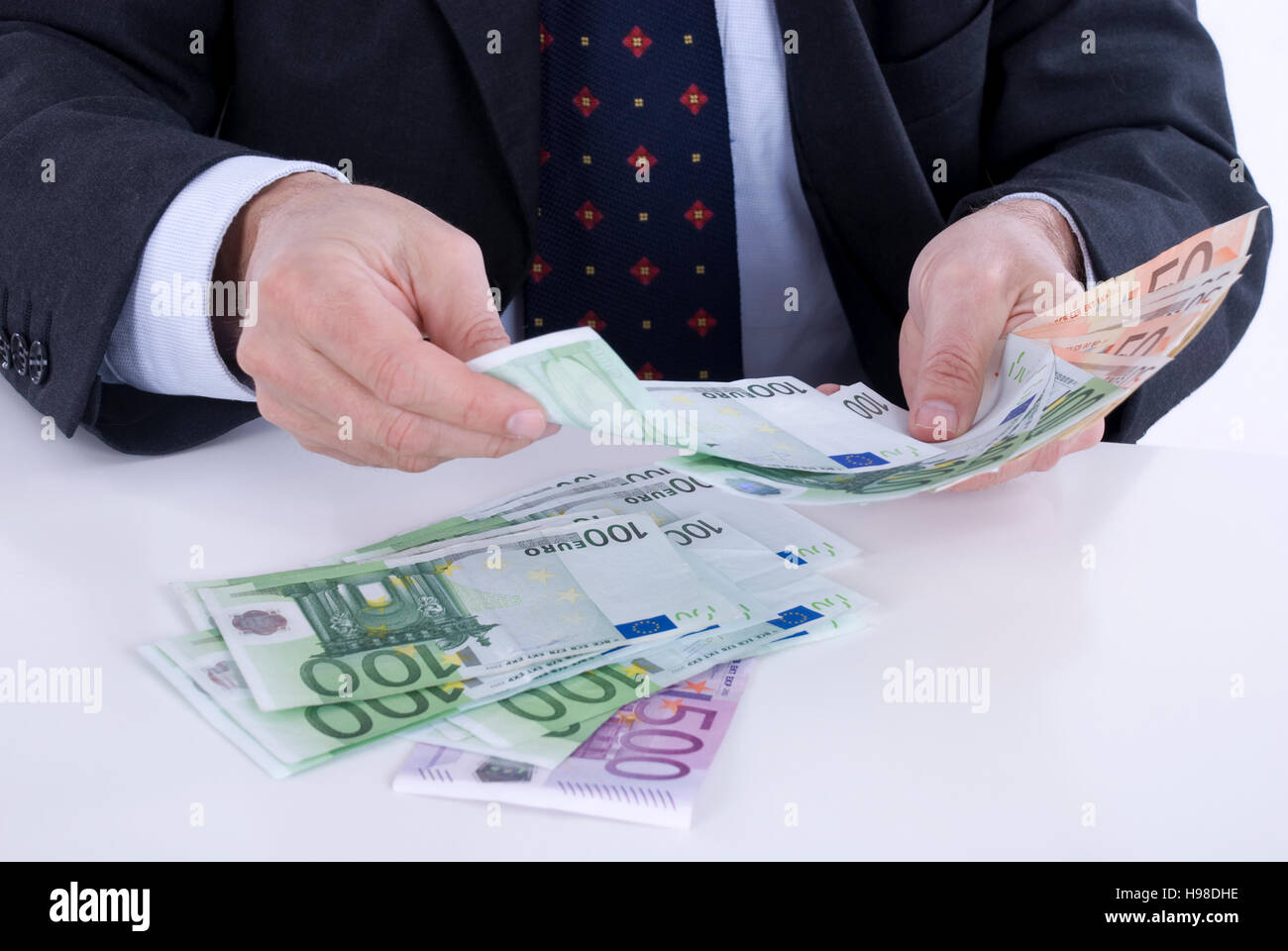 Businessman counting money Stock Photo - Alamy