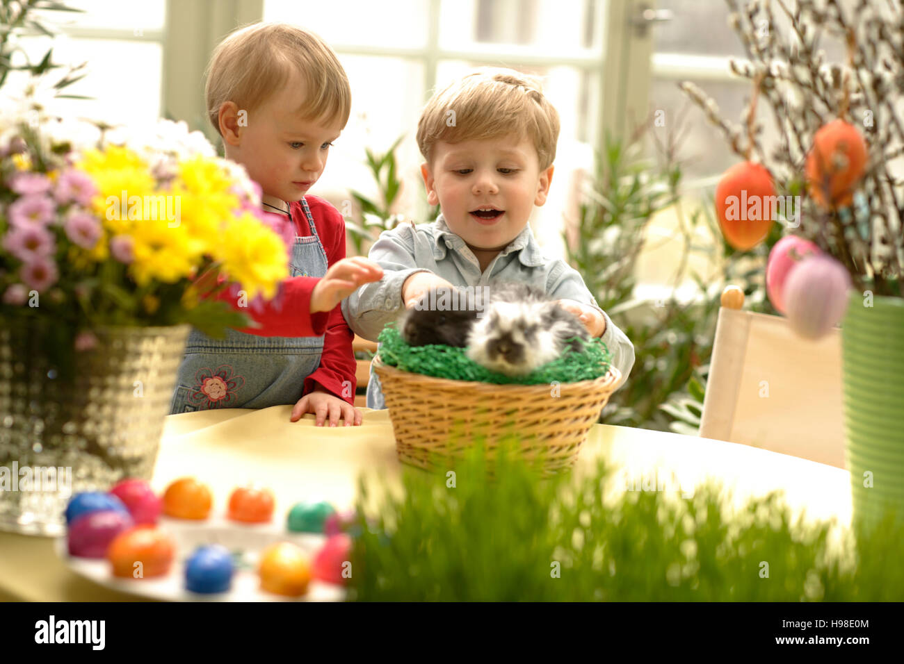 Children with rabbit, Easter decoration Stock Photo - Alamy
