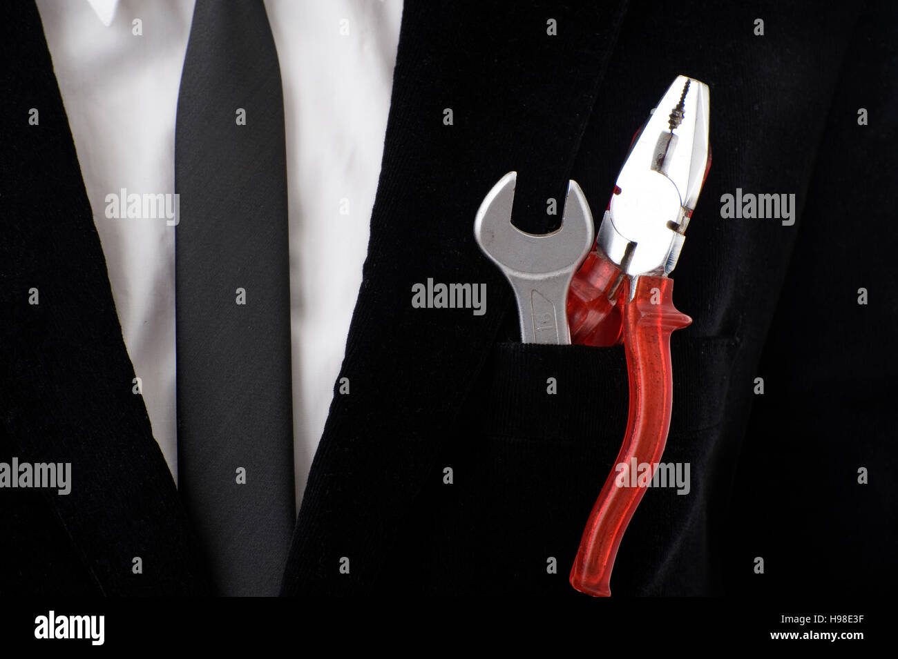 Businessman with tools Stock Photo - Alamy