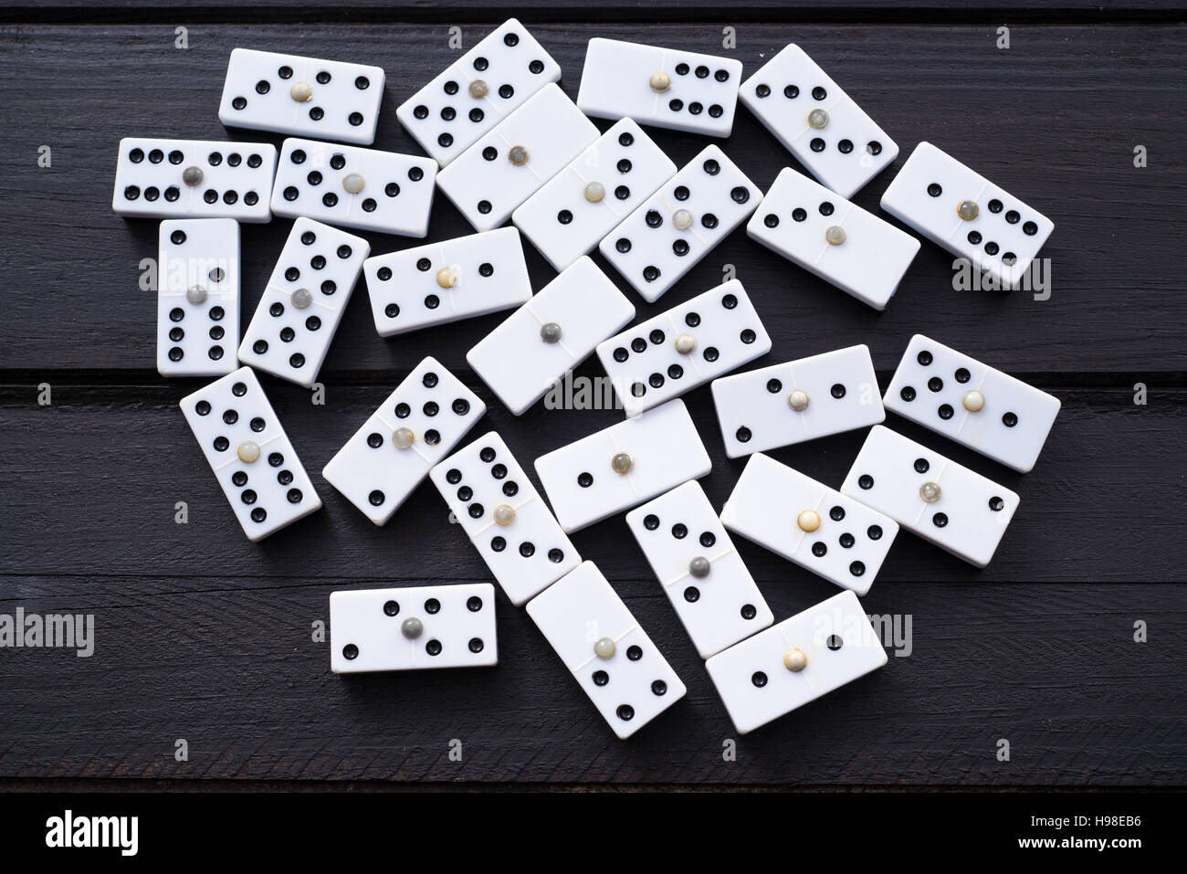 Domino game chips over black wood Stock Photo - Alamy