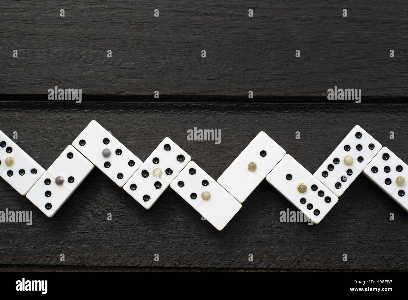Domino game chips over black wood Stock Photo - Alamy
