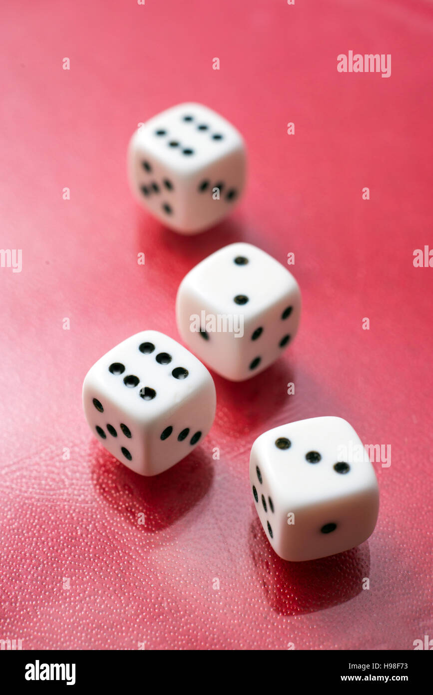 Four white dice on red background Stock Photo - Alamy