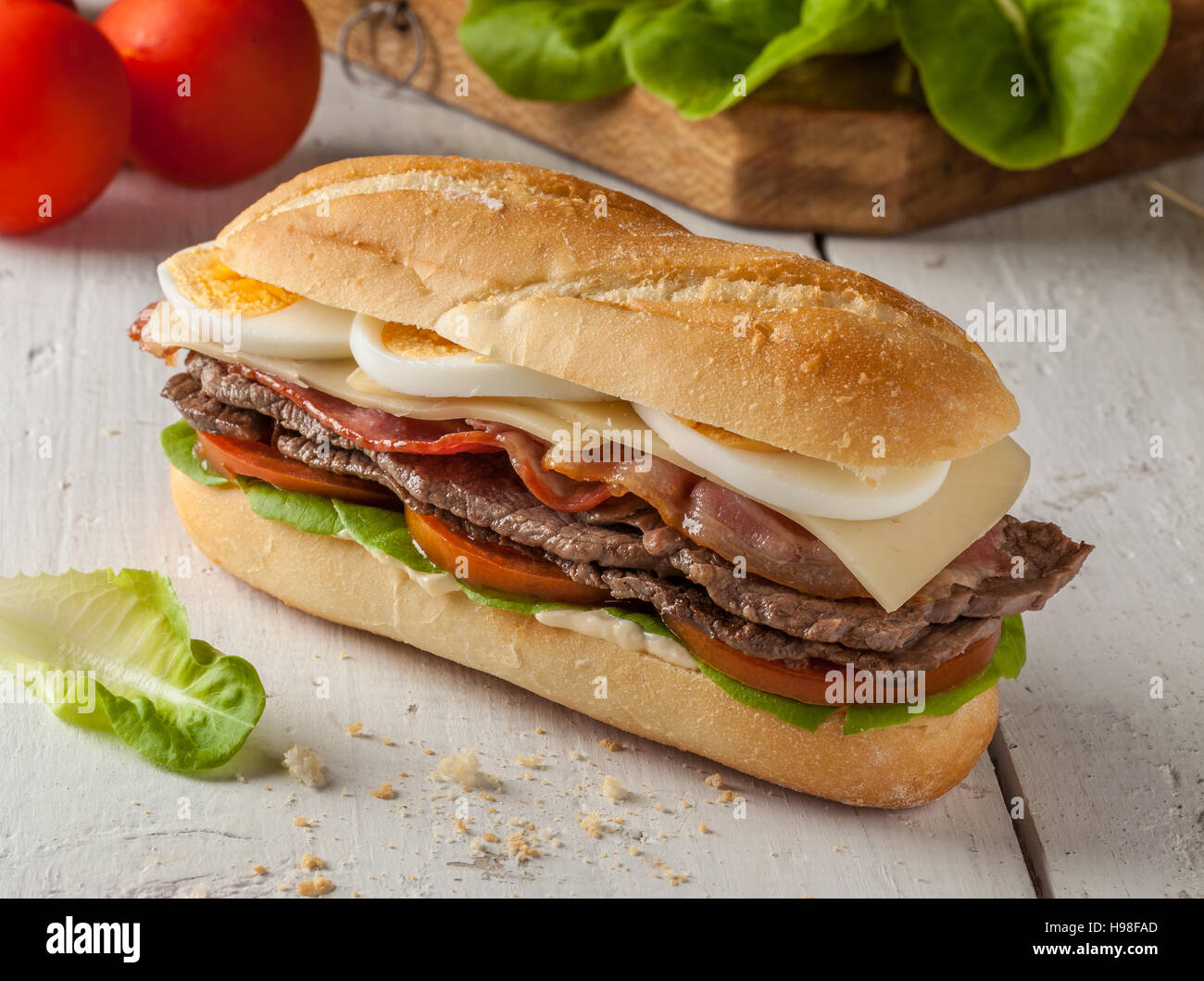 Chivito is a typical sandwich from Uruguay, with lettuce, tomato, bacon ...