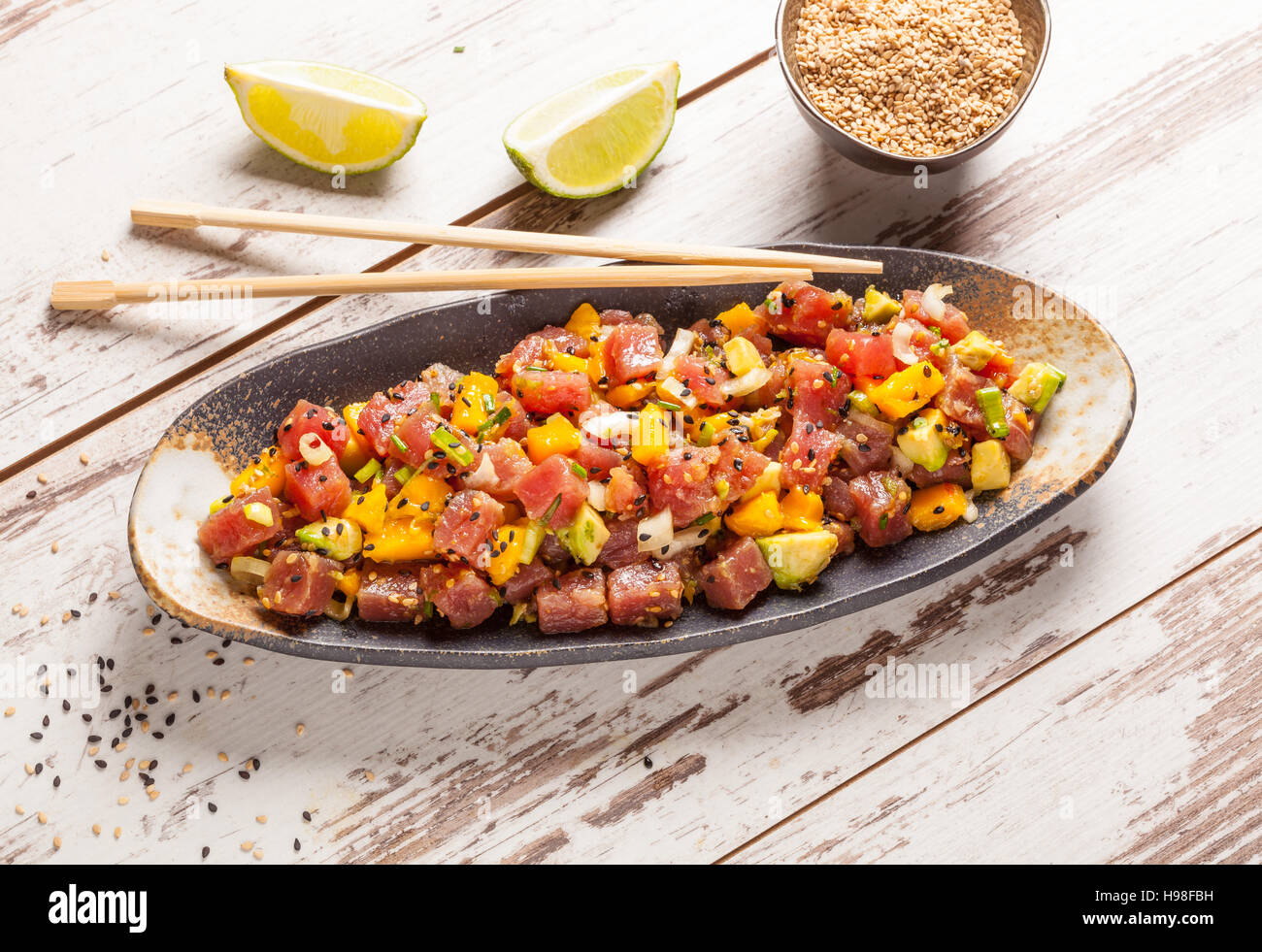 Hawaiian tuna poke with mango, avocado, onion and sesame seeds Stock ...