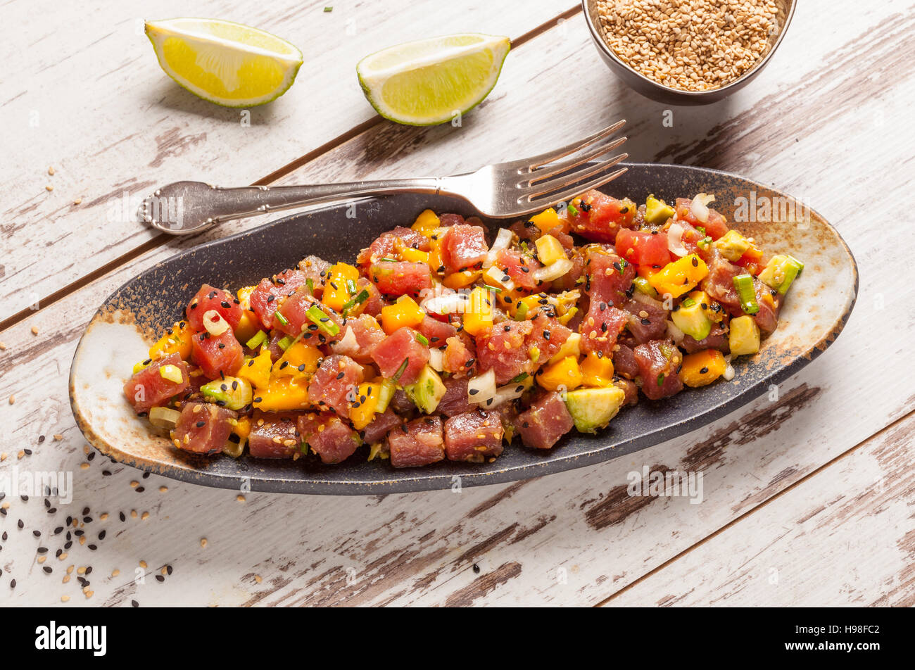 Hawaiian tuna poke with mango, avocado, onion and sesame seeds Stock ...