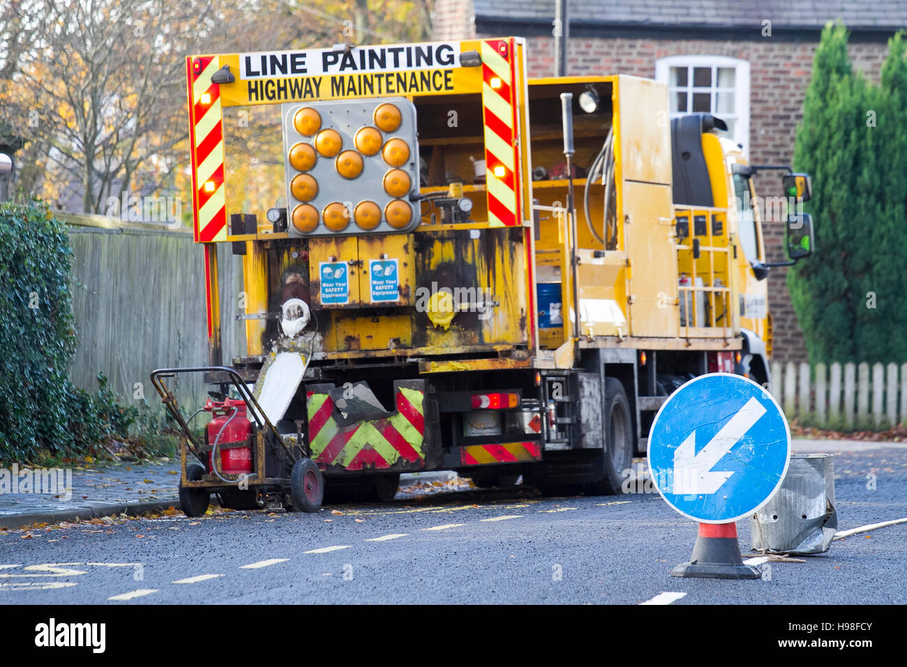 Line painting over a newly tarmacked road surface Stock Photo - Alamy