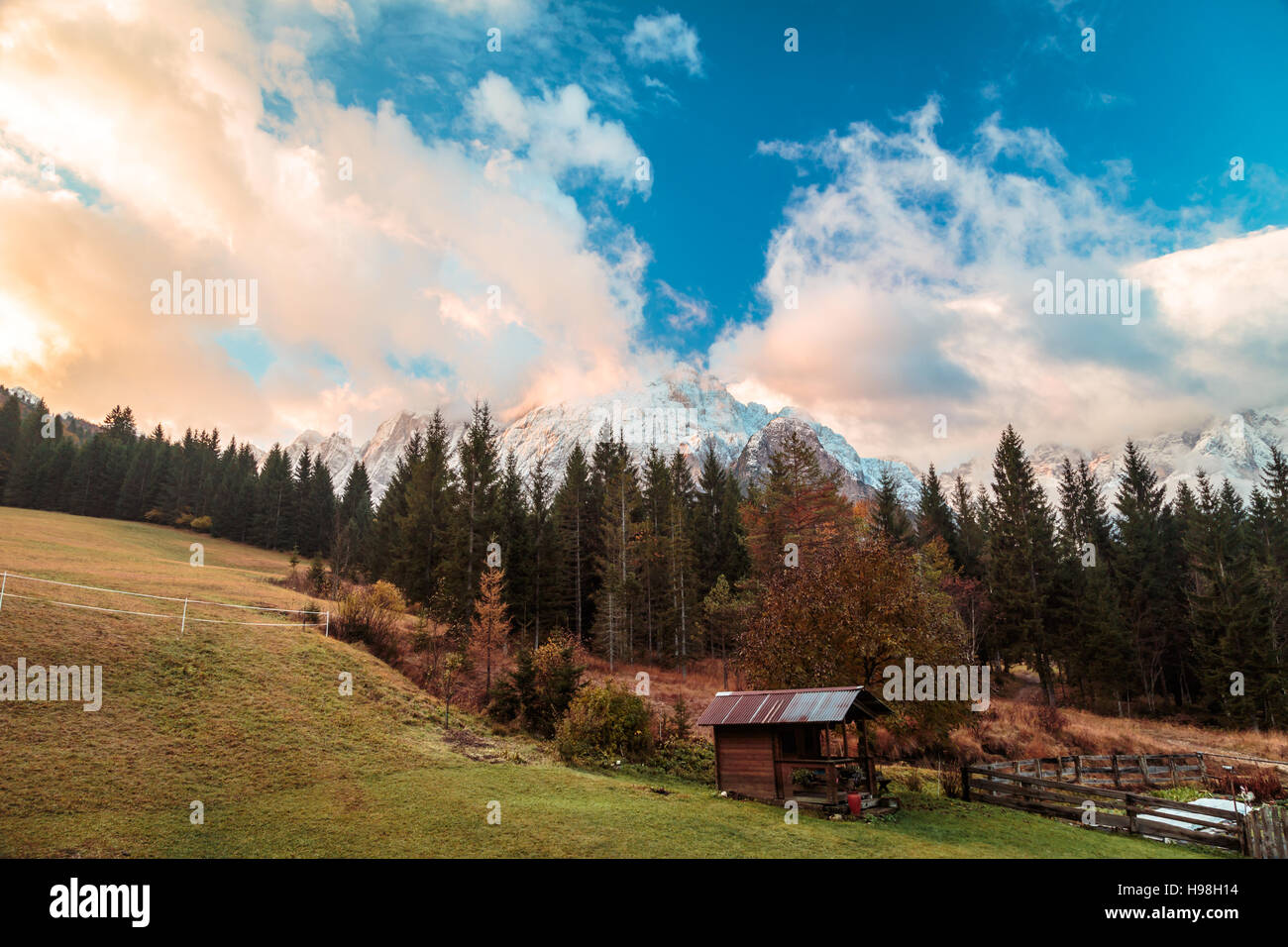 an alpine hut in the valley during a colorful sunrise Stock Photo - Alamy
