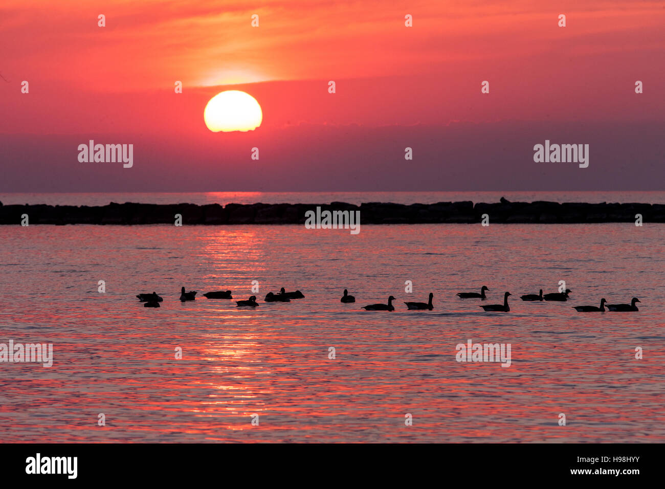 The sun begins to set over Lake Huron along the shoreline near Goderich ...