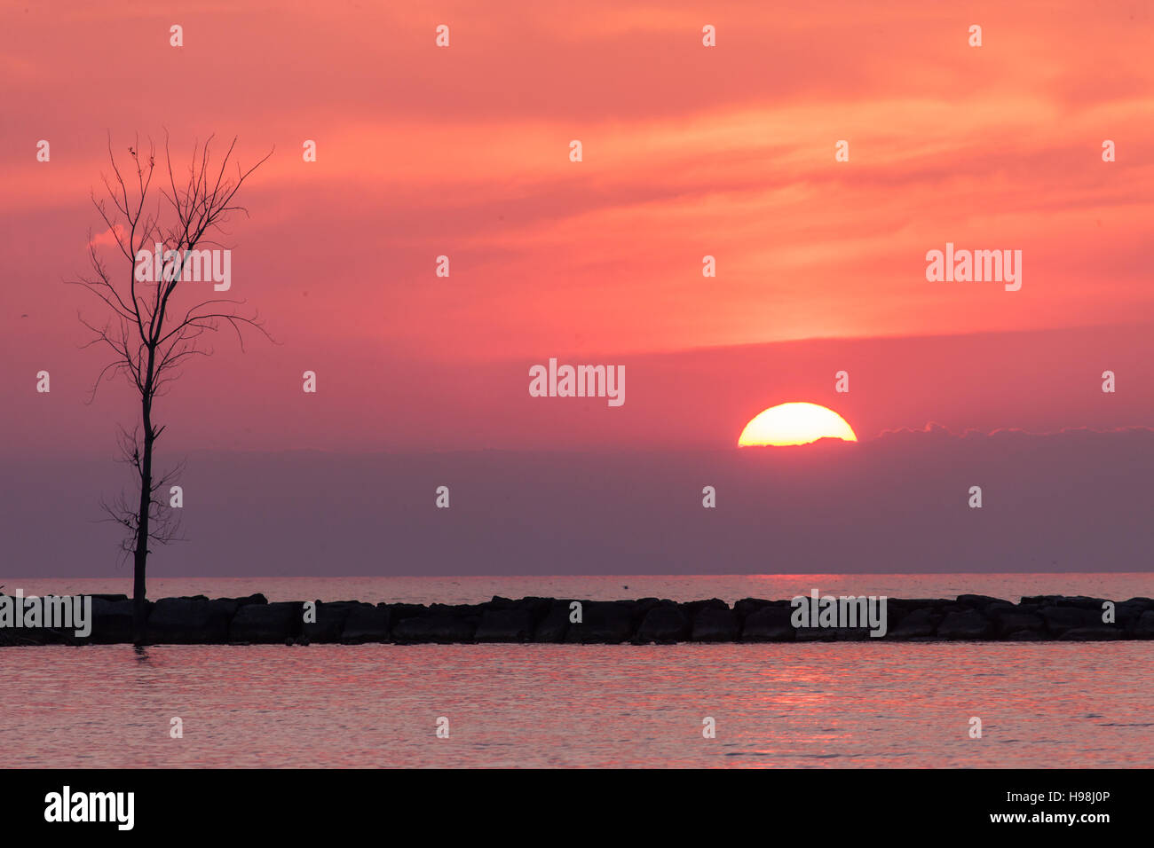 The sun begins to set over Lake Huron along the shoreline near Goderich ...