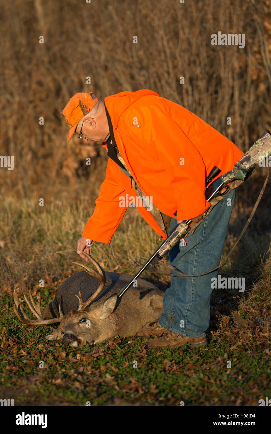 A deer hunter with a large Whitetail Buck Stock Photo - Alamy