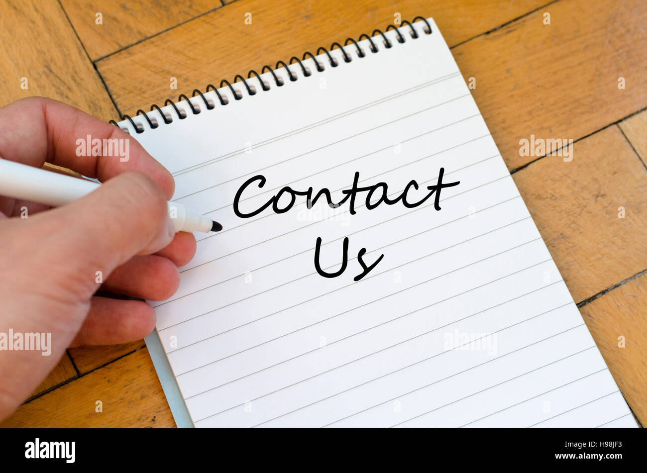 Contact us text concept write on notebook Stock Photo - Alamy