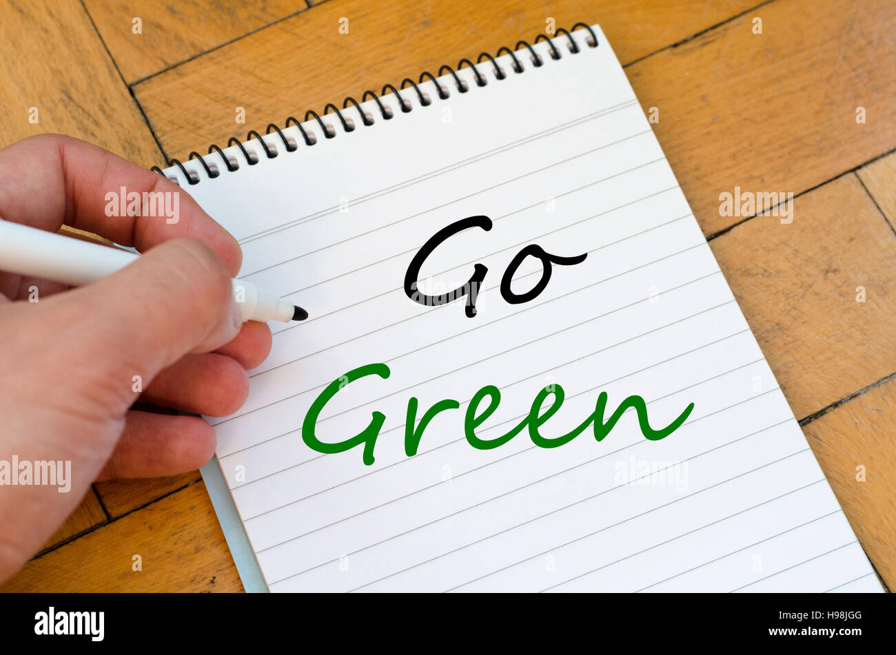 Go green text concept write on notebook Stock Photo - Alamy