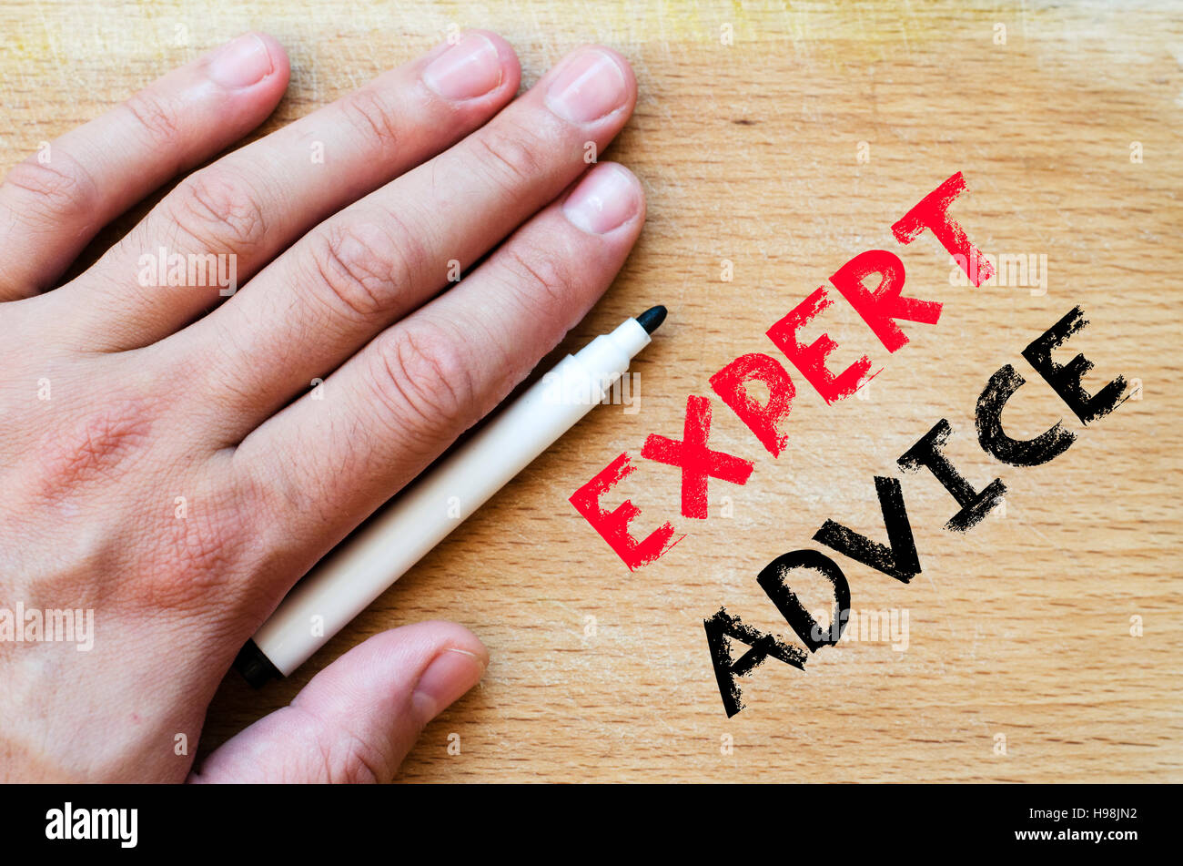Human hand over wooden background and expert advice text concept Stock ...