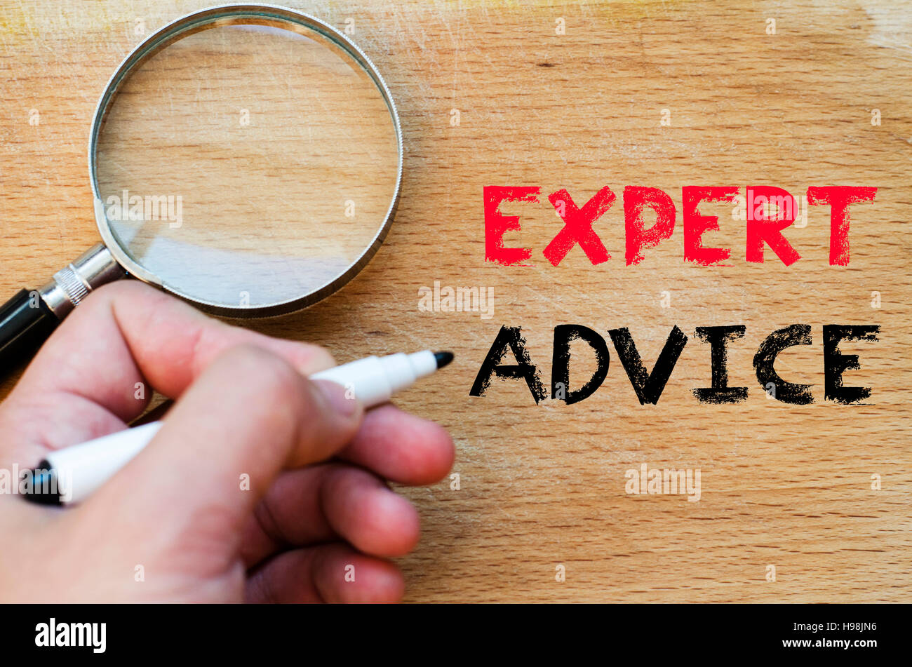 Human hand over wooden background and expert advice text concept Stock ...
