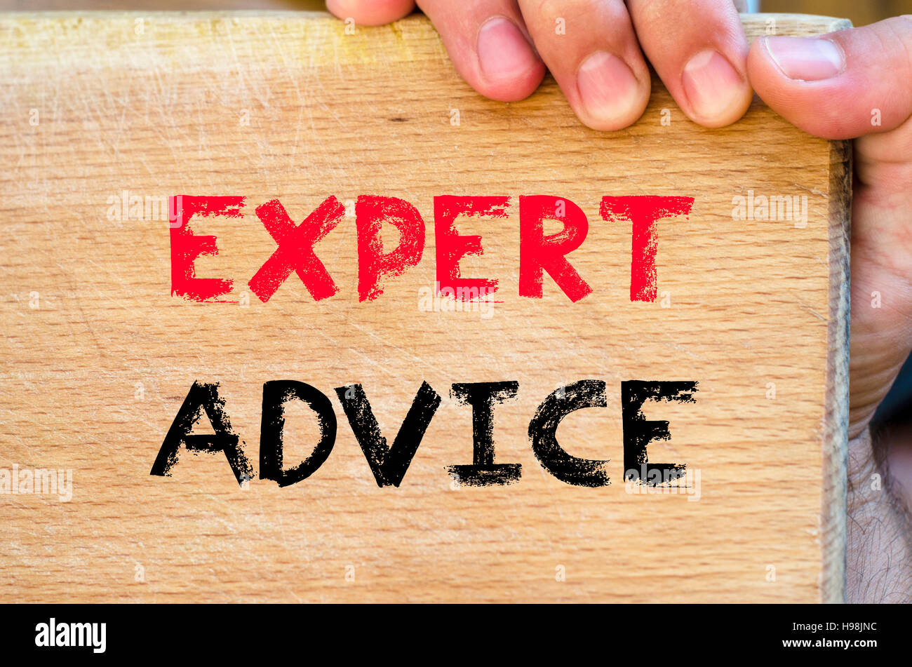 Human hand over wooden background and expert advice text concept Stock ...