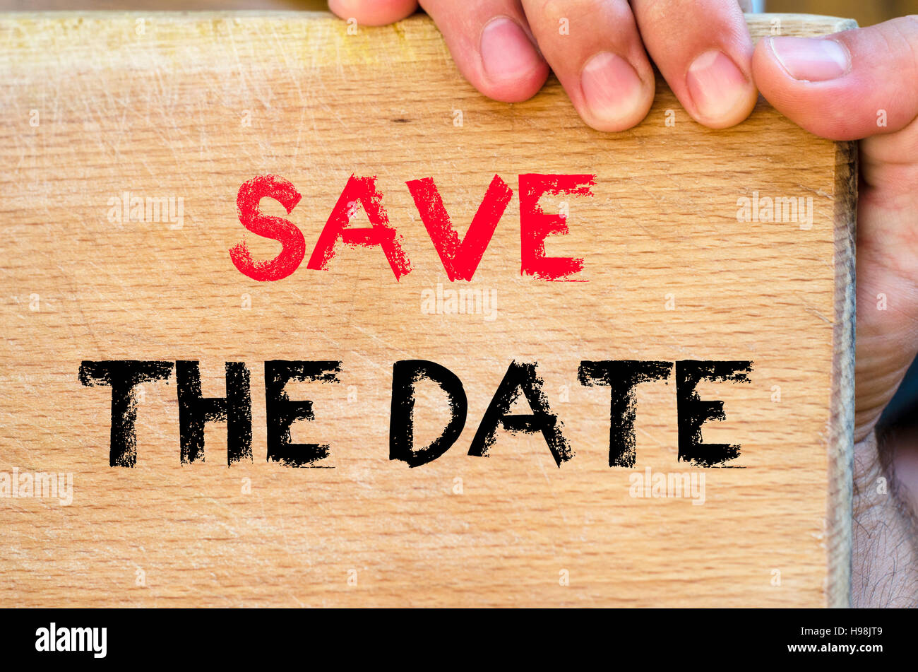 Human hand over wooden background and save the date text concept Stock ...