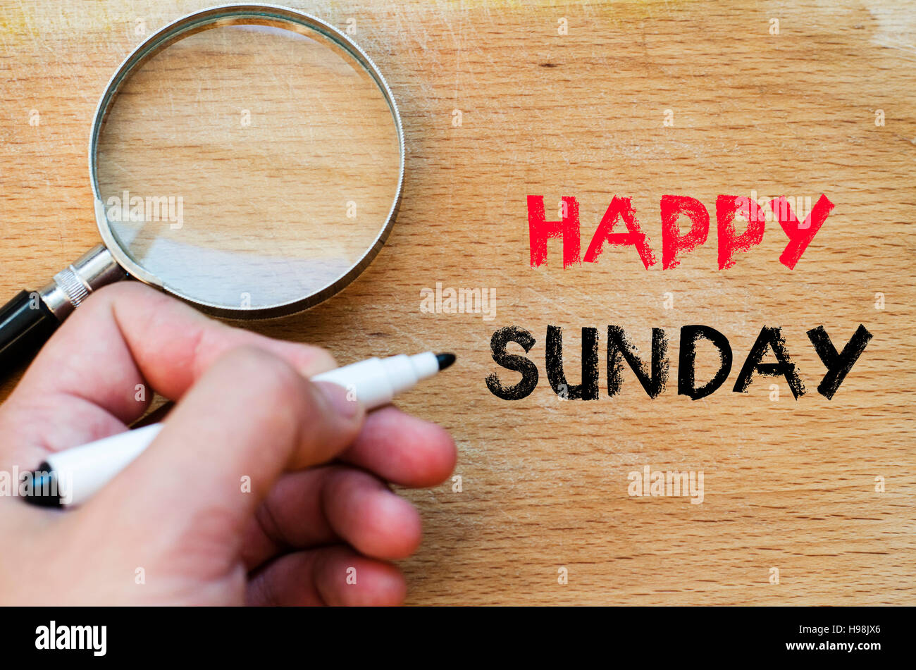 Human hand over wooden background and happy sunday text concept Stock ...