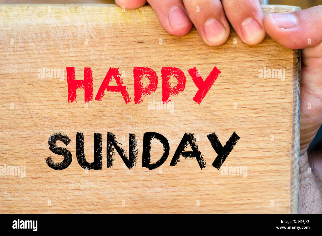 Human hand over wooden background and happy sunday text concept Stock ...