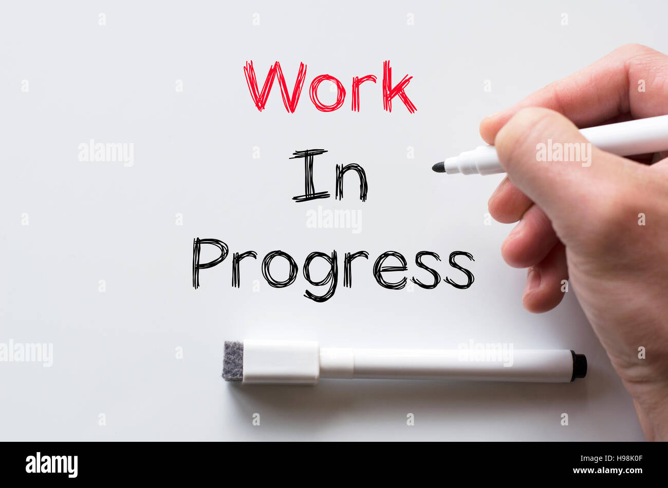 Human hand writing work in progress on whiteboard Stock Photo - Alamy